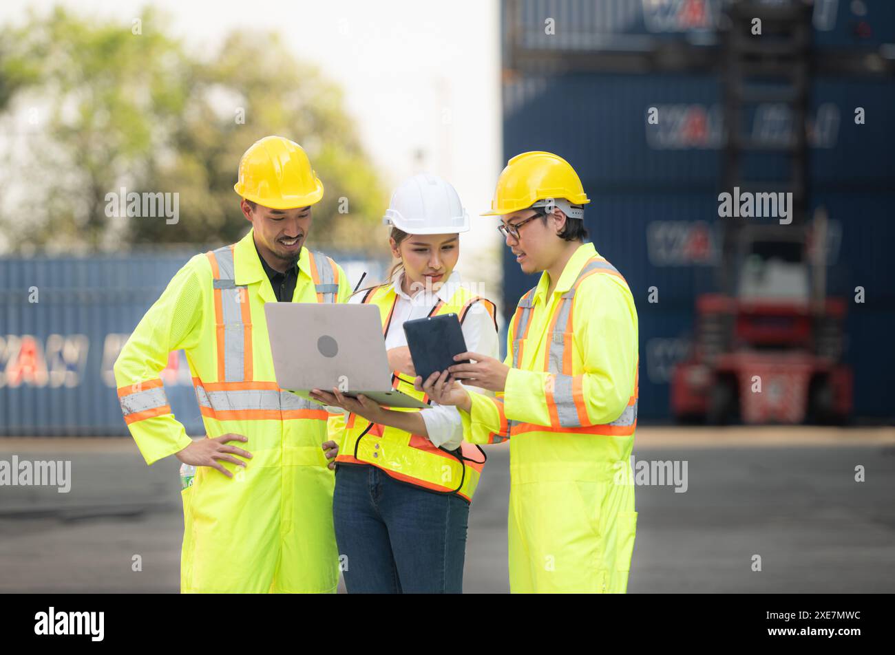Group of engineers working with laptop in the container yard. This is a ...