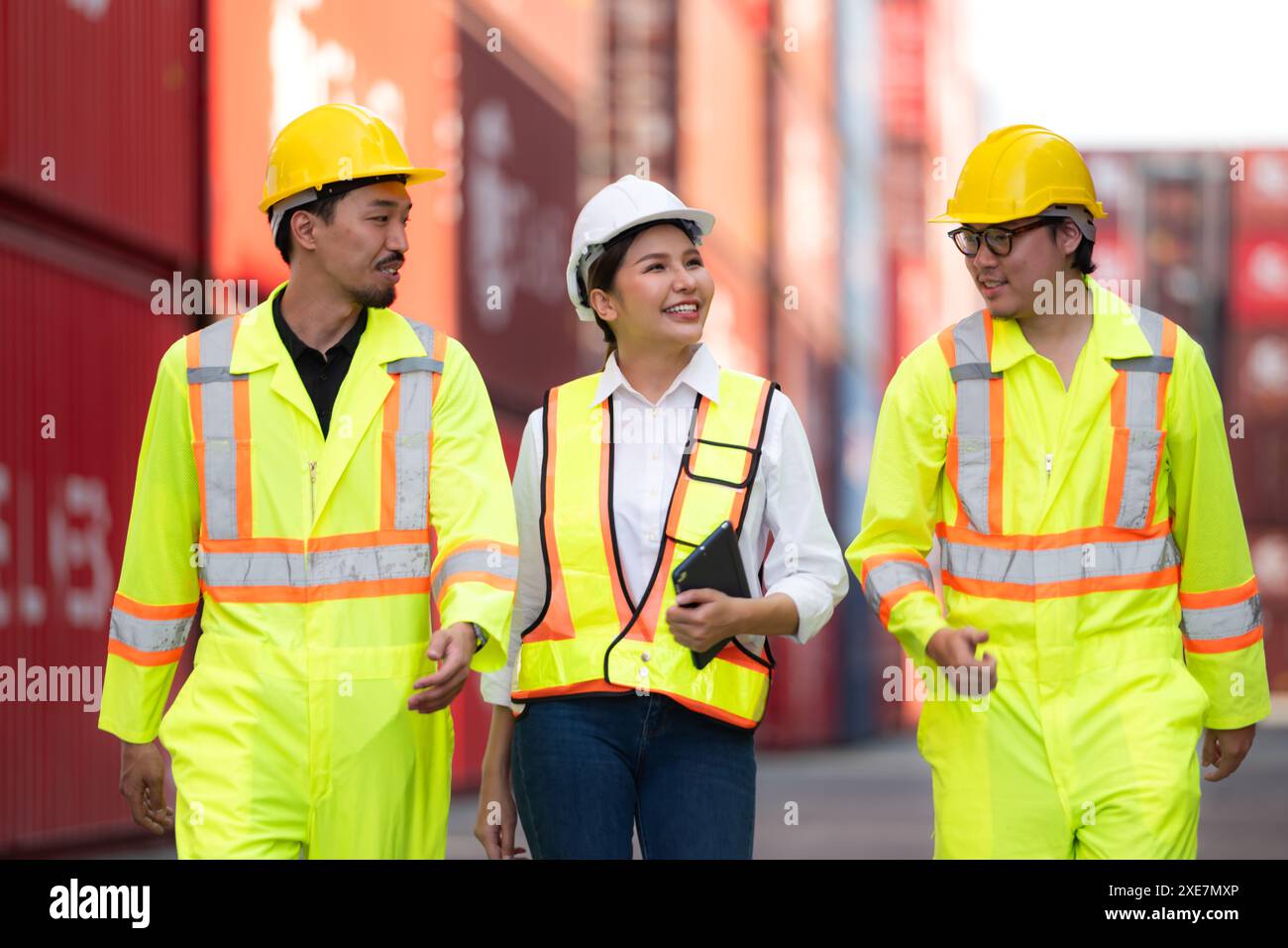 Group of engineers working with laptop in the container yard. This is a freight transportation ...