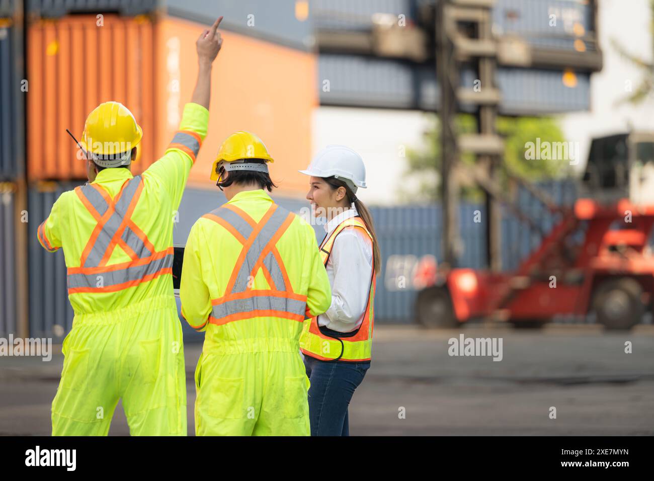 Group of workers in the import and export industry use walkie talkies ...