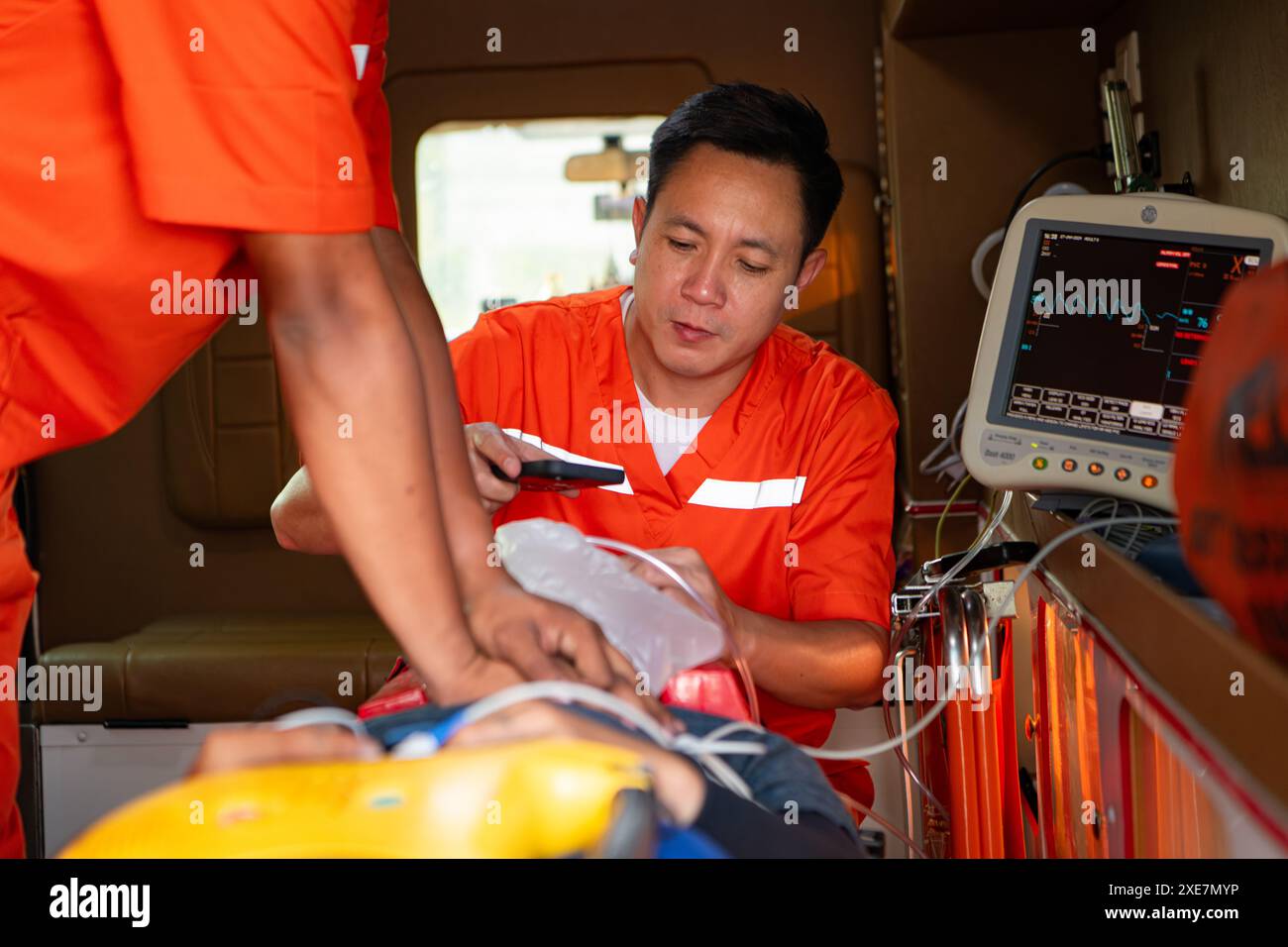 The rescue team is administering CPR to a patient who was involved in an ambulance accident ...