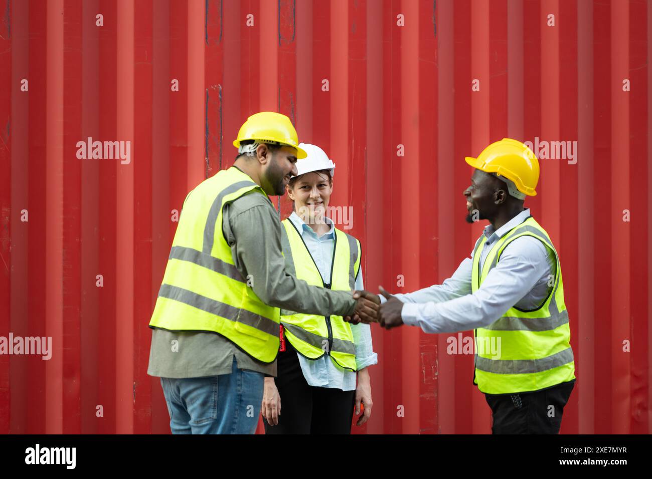 Group of workers in a container storage yard greeting each other during ...