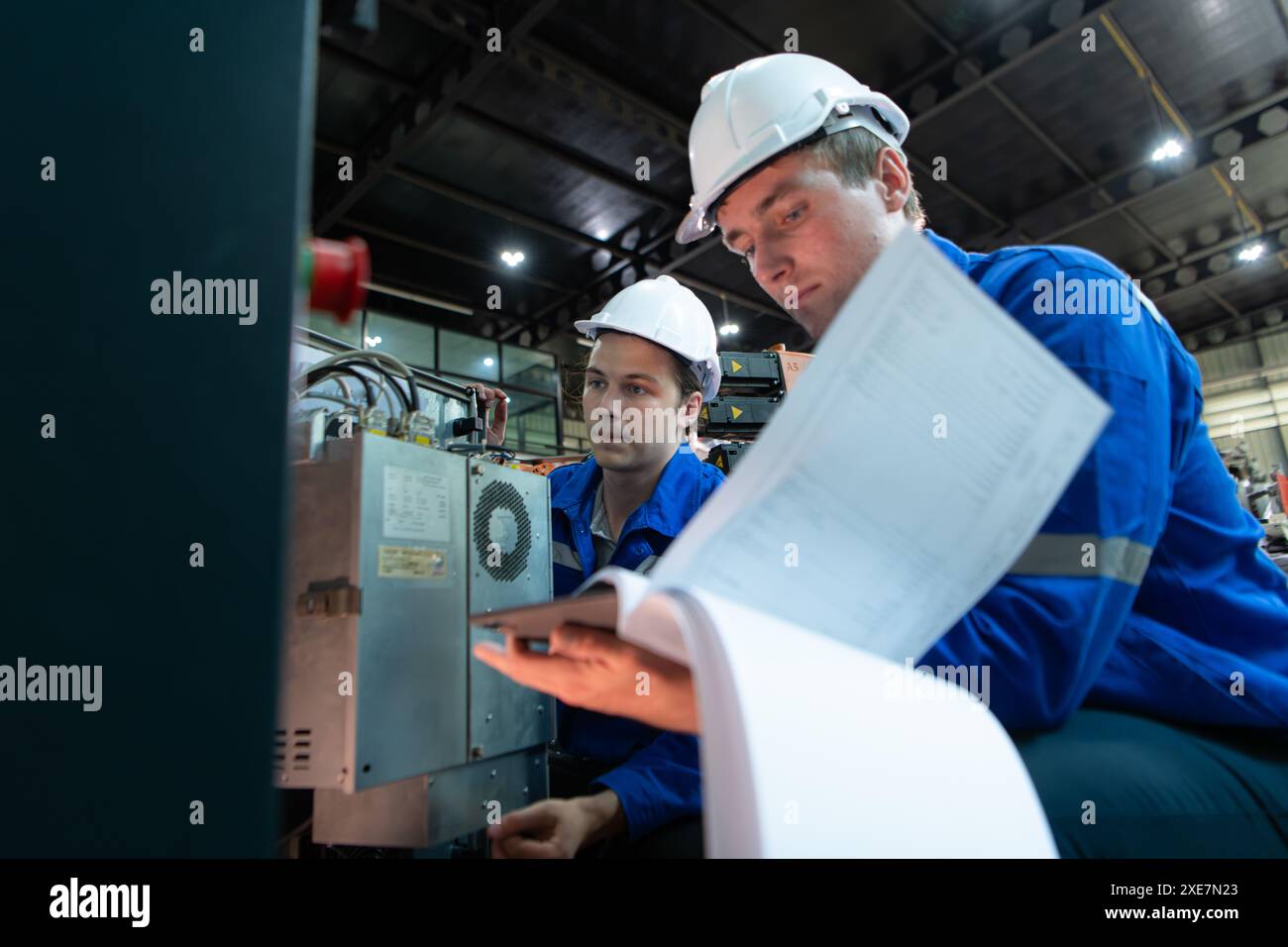 Technician working on the electrical control cabinet of robotic arm ...