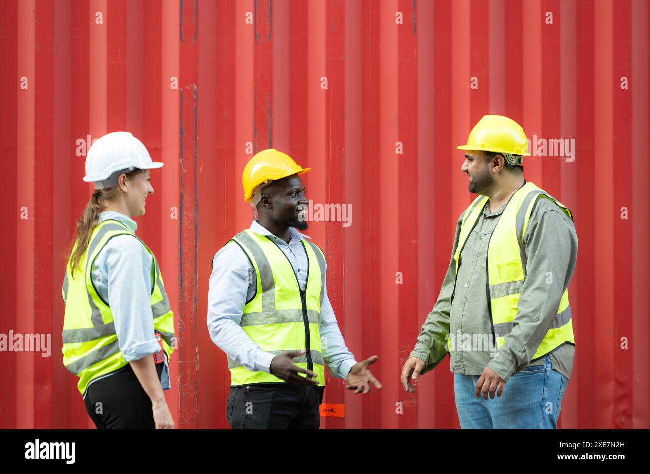 Group of workers in a container storage yard greeting each other during ...