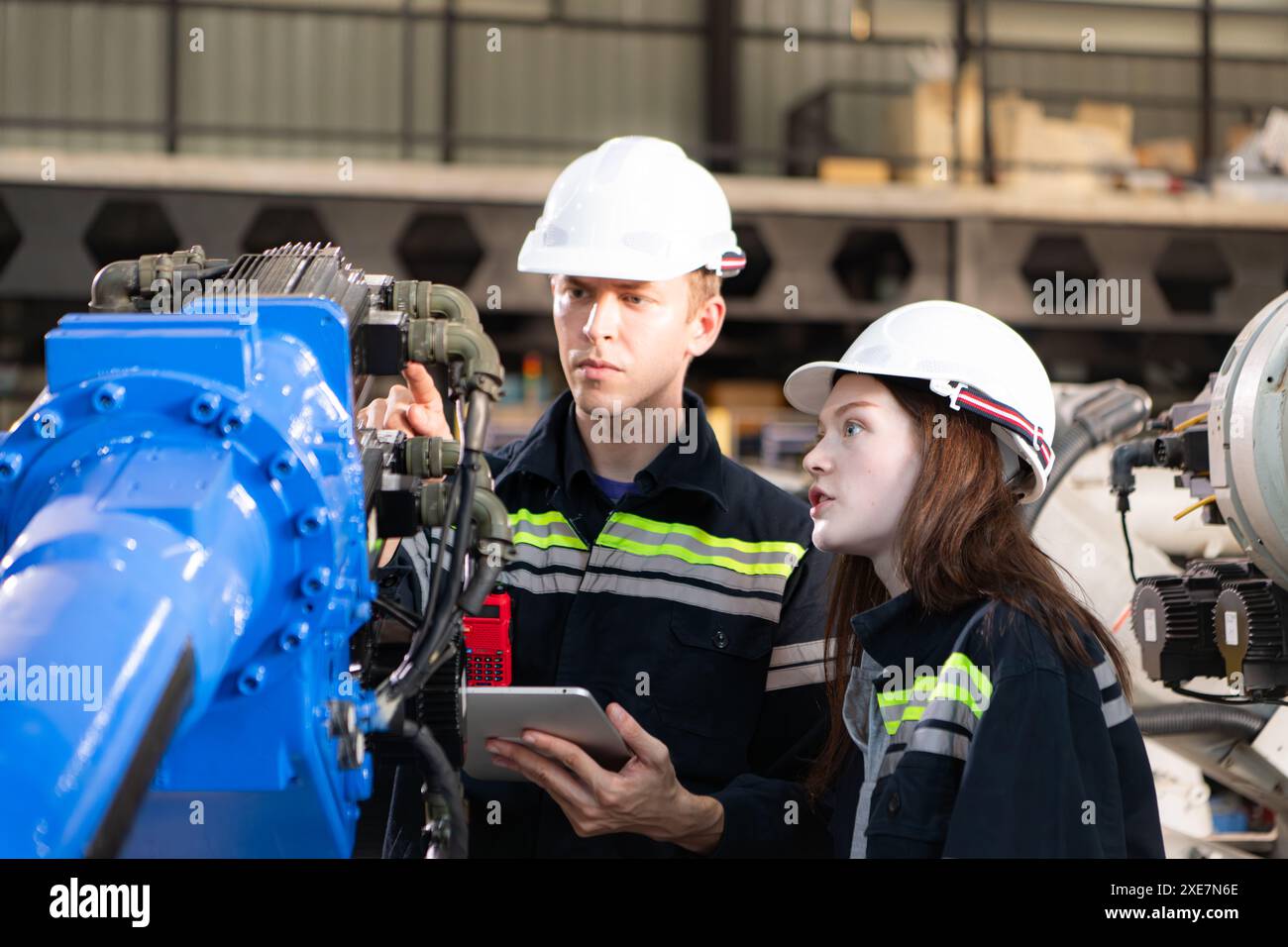 Both of engineers working together in a robotic arm factory, Robotic ...