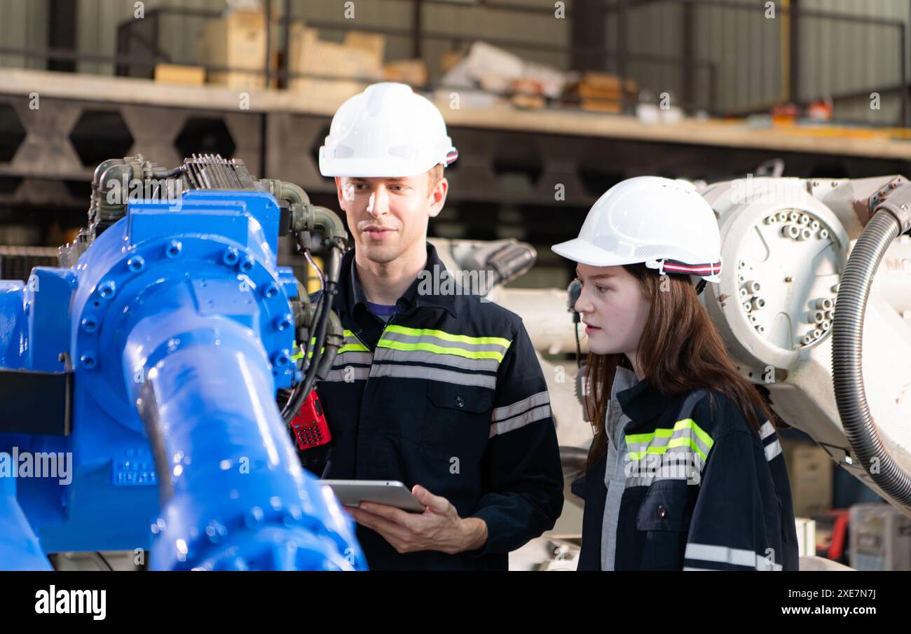 Both of engineers working together in a robotic arm factory, Robotic ...