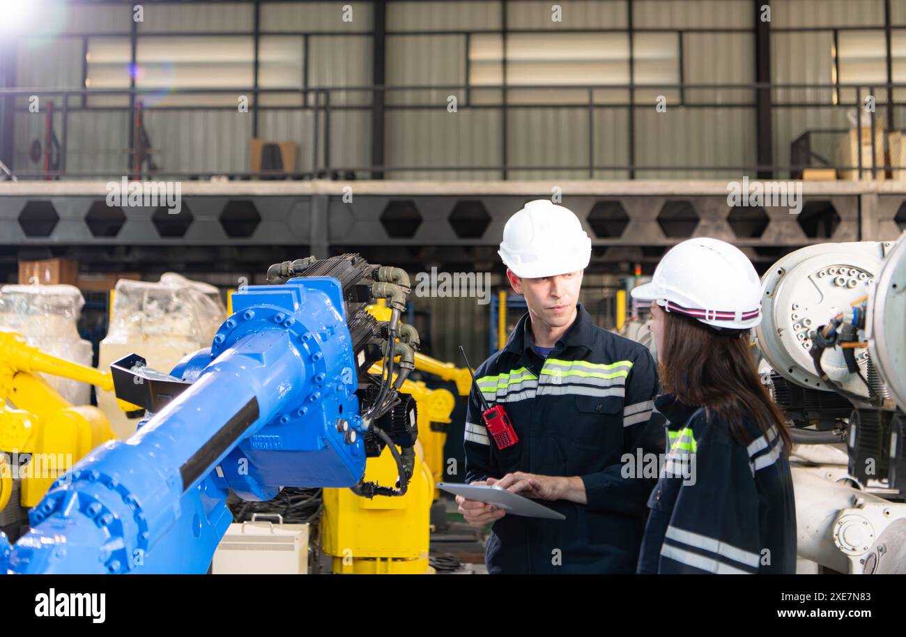 Both of engineers working together in a robotic arm factory, Robotic ...