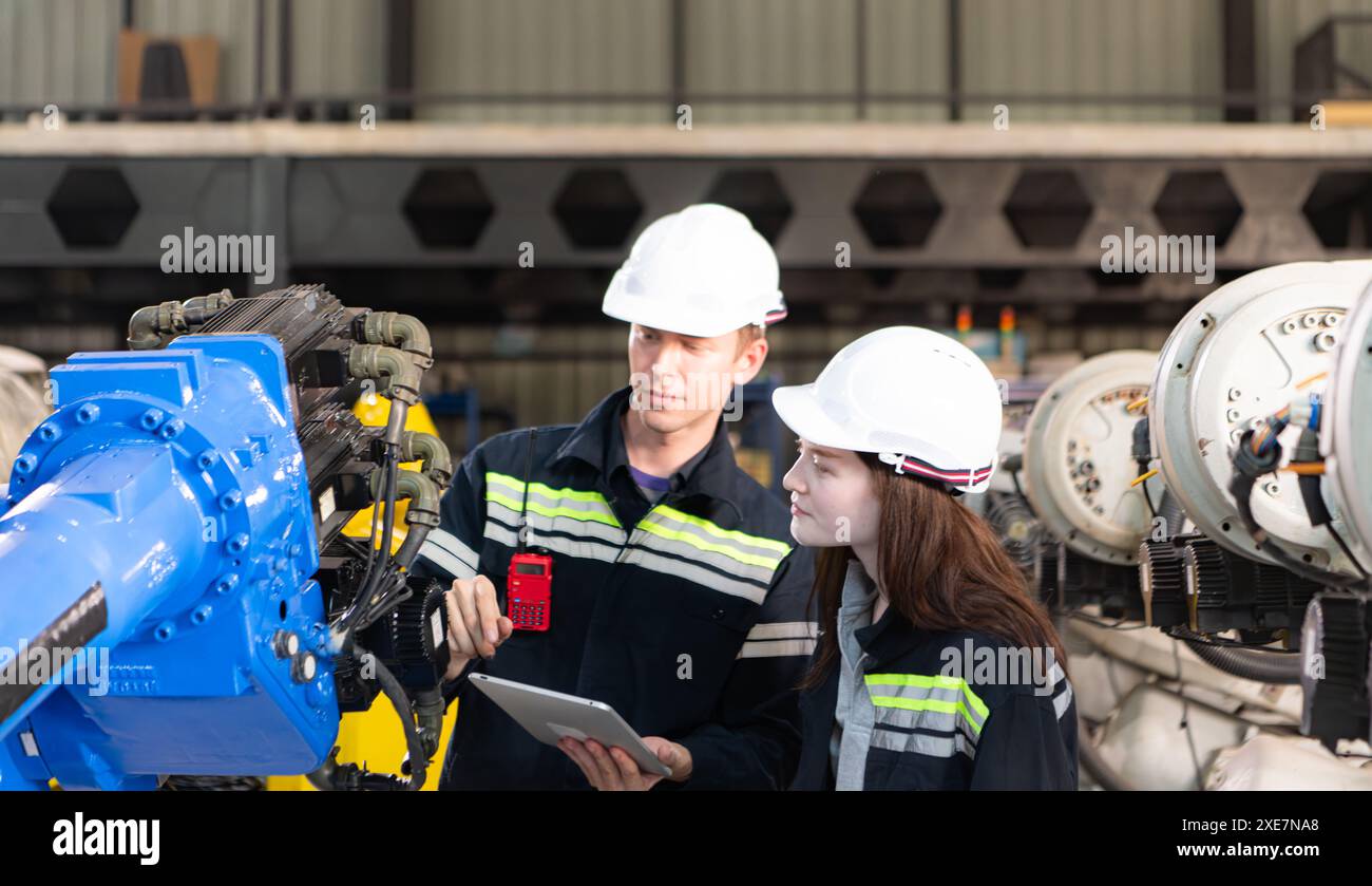 Both of engineers working together in a robotic arm factory, Robotic ...