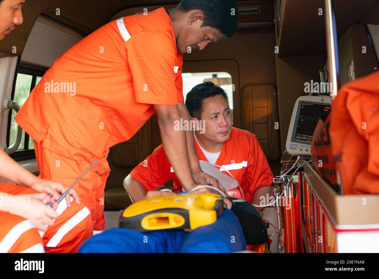 The rescue team is administering CPR to a patient who was involved in an ambulance accident ...