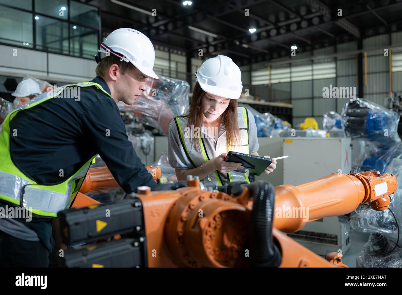 Both of engineers working together in a robotic arm factory, Robotic ...