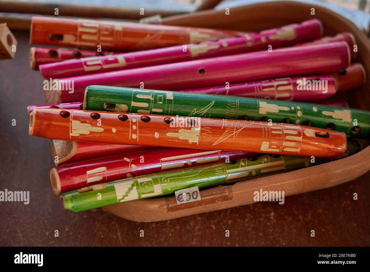 colorful wooden flutes in a basket for sale at an artisan fair in Jujuy ...