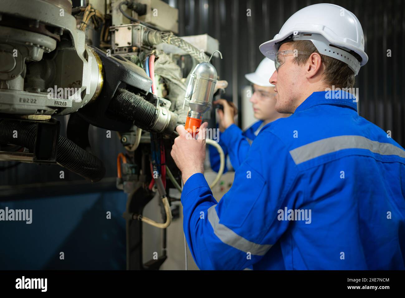 Both of engineers working together in a robotic arm factory, Robotic ...