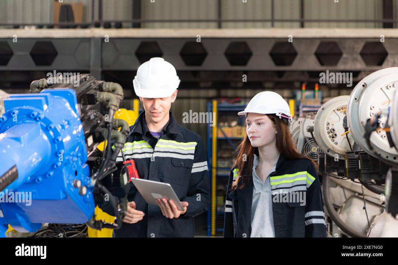 Both of engineers working together in a robotic arm factory, Robotic ...