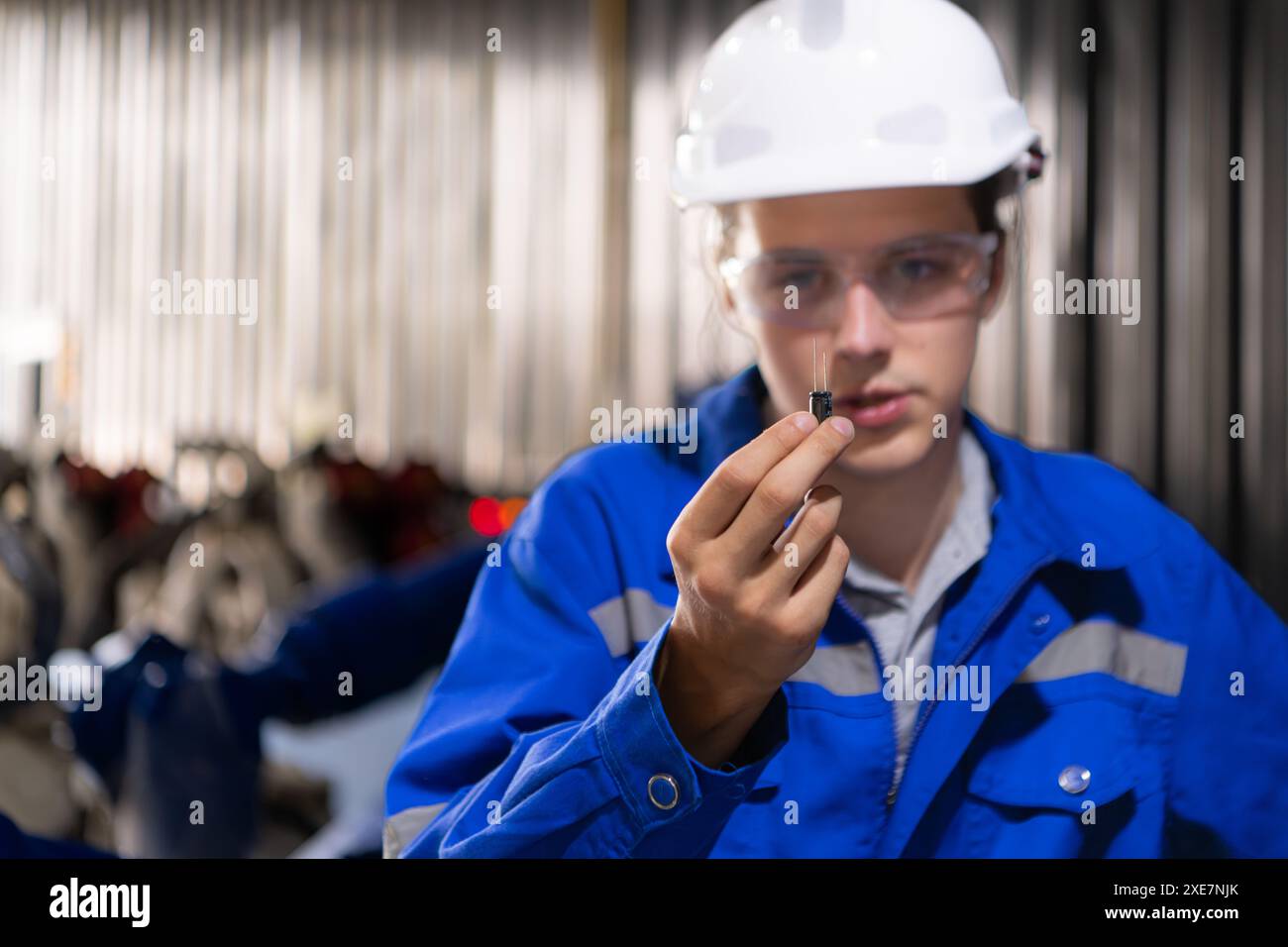 Engineers and technicians working together in a robotic arm factory ...