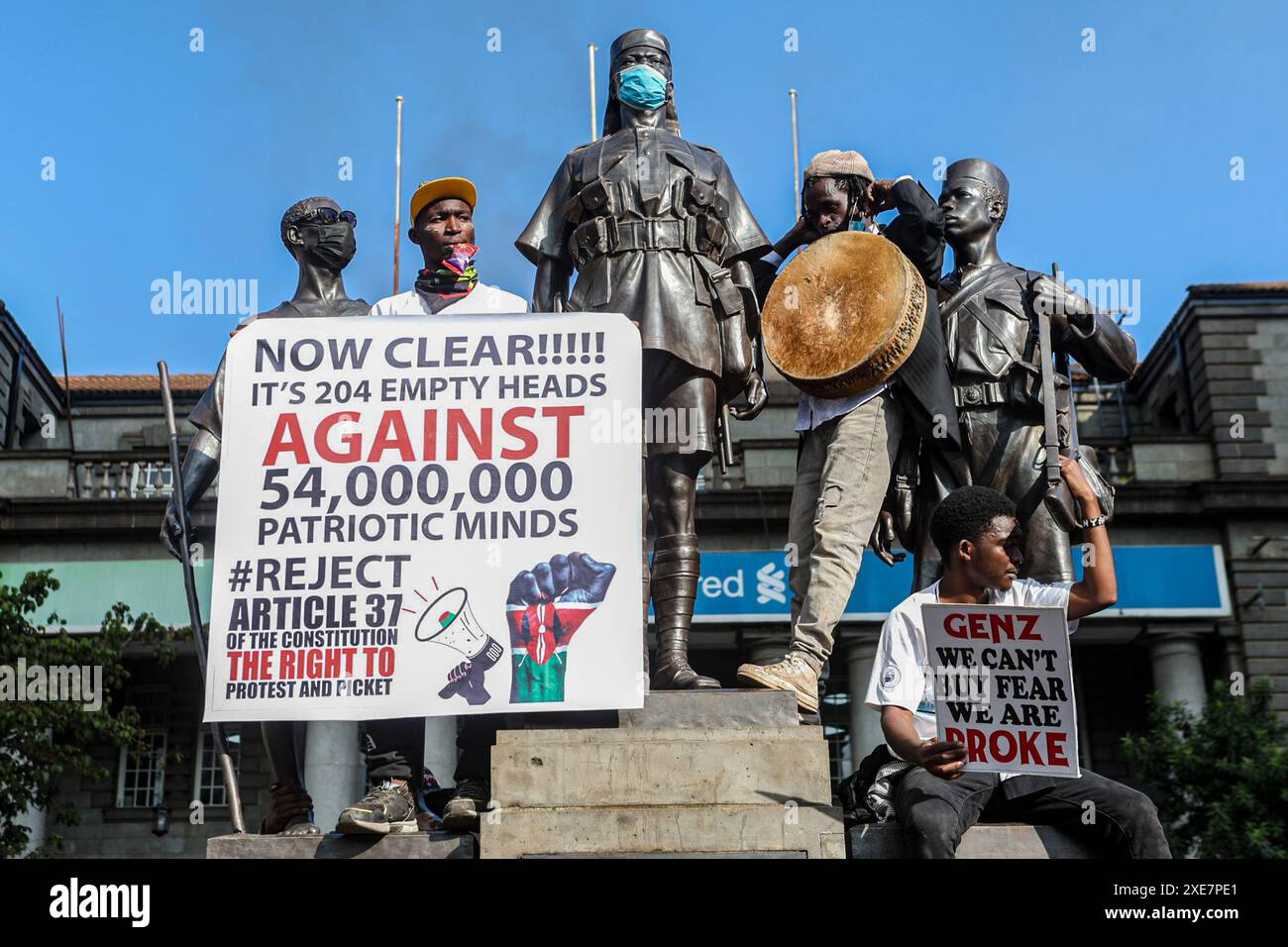 Protesters hold a placards and shout slogans, during the demonstration ...