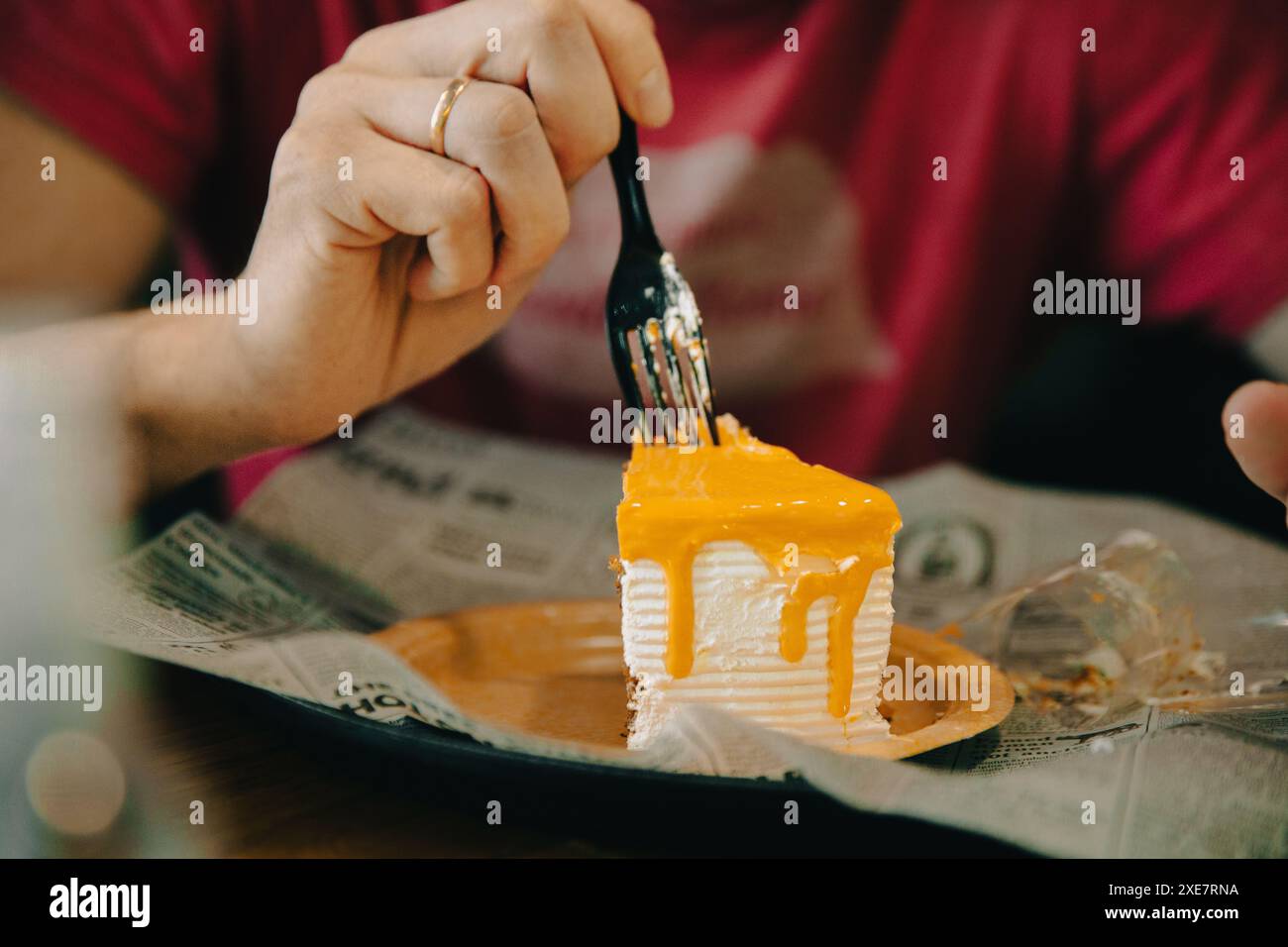 A man's hand breaks off a piece of cake with a fork Stock Photo - Alamy