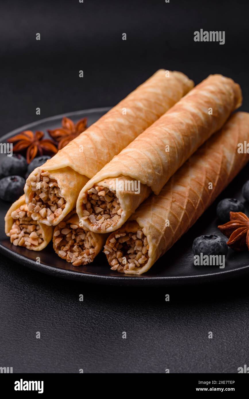 Delicious crispy wafer rolls with cream filling with nuts Stock Photo ...