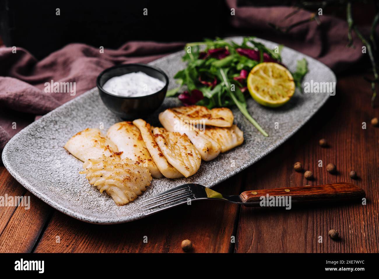 Fried white fish fillet with arugula Stock Photo - Alamy