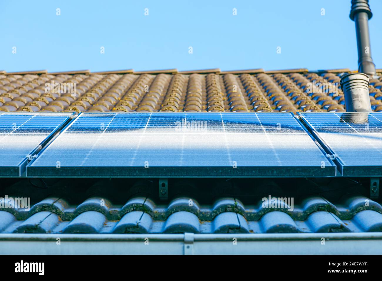 Snow-proof solar panels in icy weather. frost at panel at rooftop. Snow ...