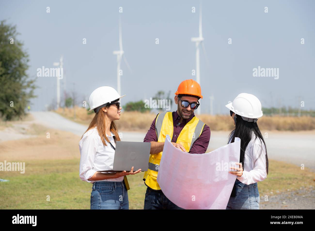 Group of engineers and architects on construction site with wind ...