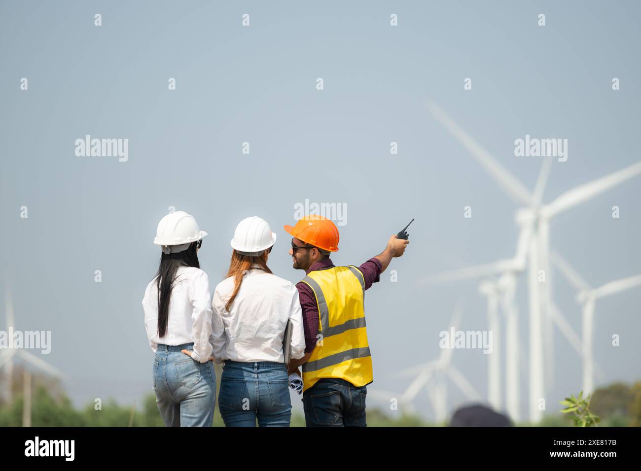 Back view of group engineers and architects on construction site with ...