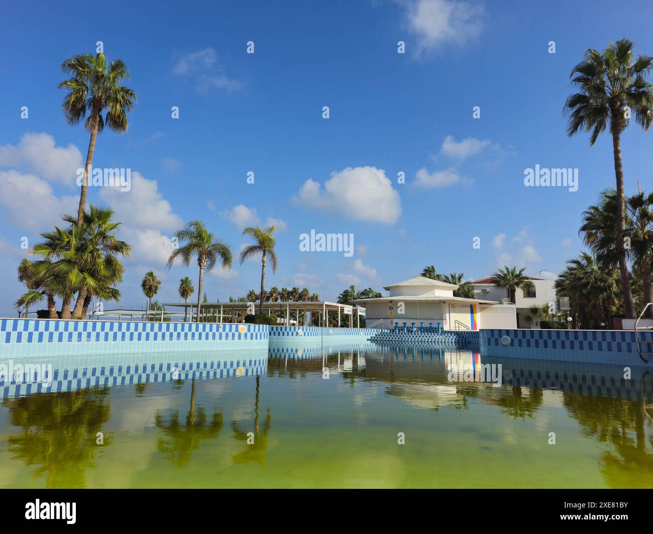 Drone aerial of abandoned deserted hotel swimming pool. Hotel is close ...