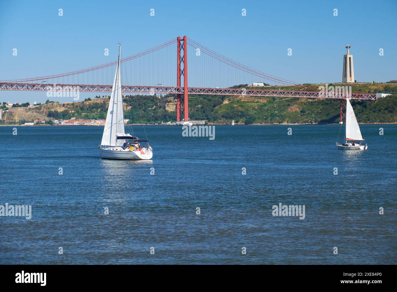 25th of April Bridge suspension bridge over river Tejo with Jesus ...