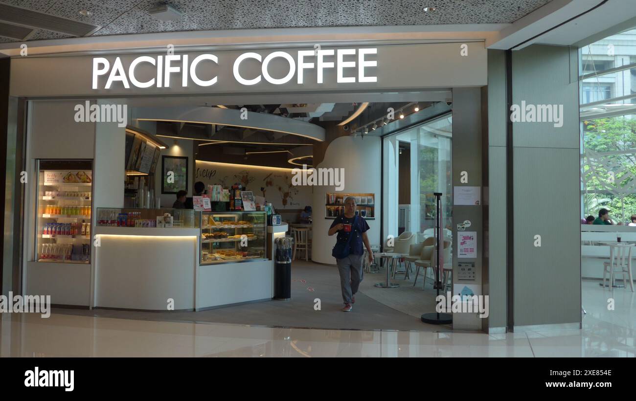 A photograph shows a customer holds a cup of coffee in the coffee house ...