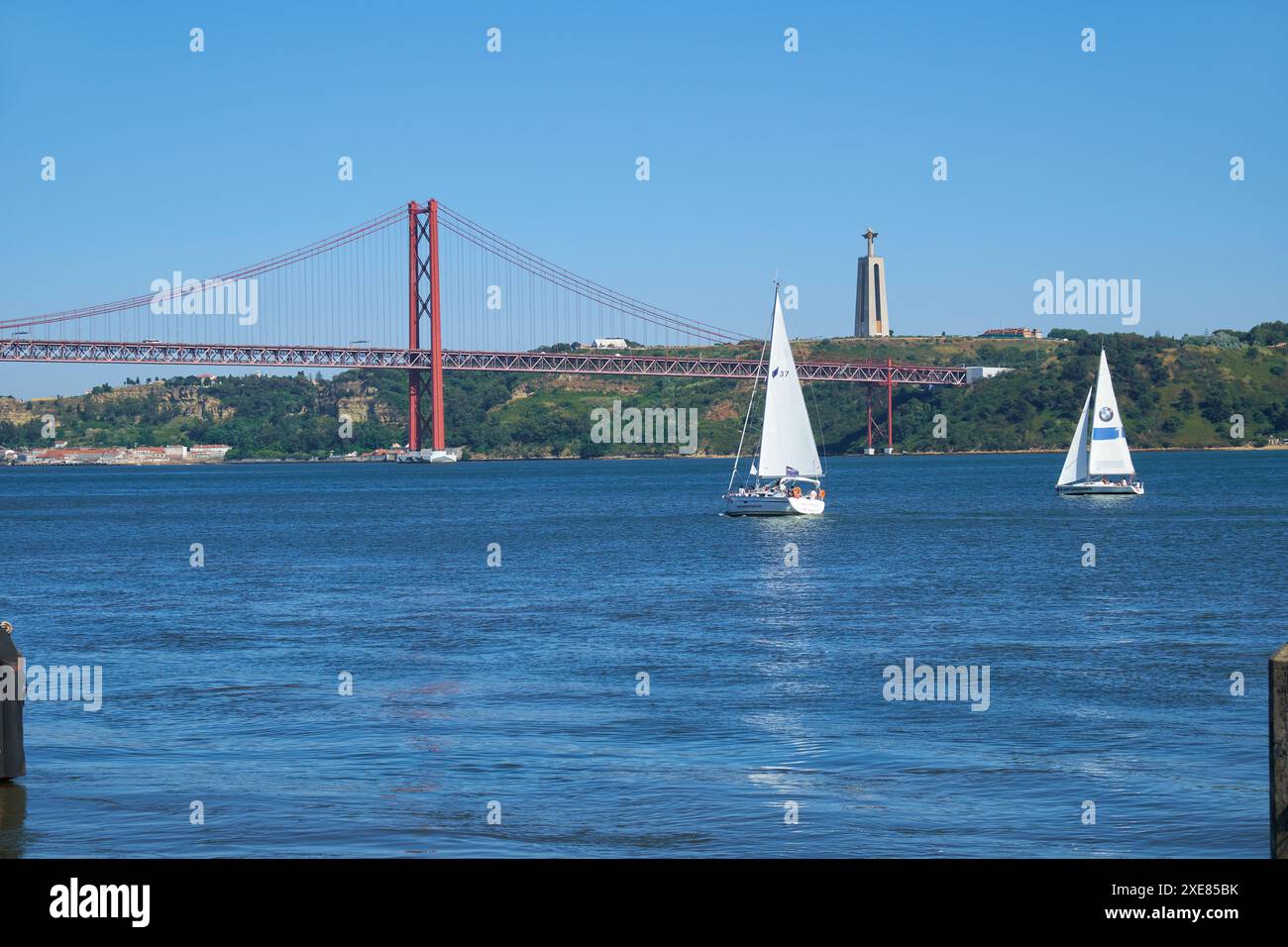 25th of April Bridge suspension bridge over river Tejo with Jesus ...