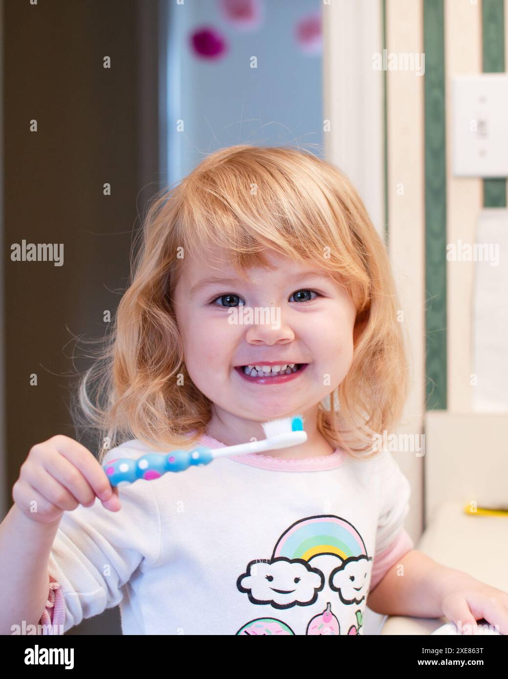 Toddler girl brushing teeth with toothbrush Stock Photo - Alamy