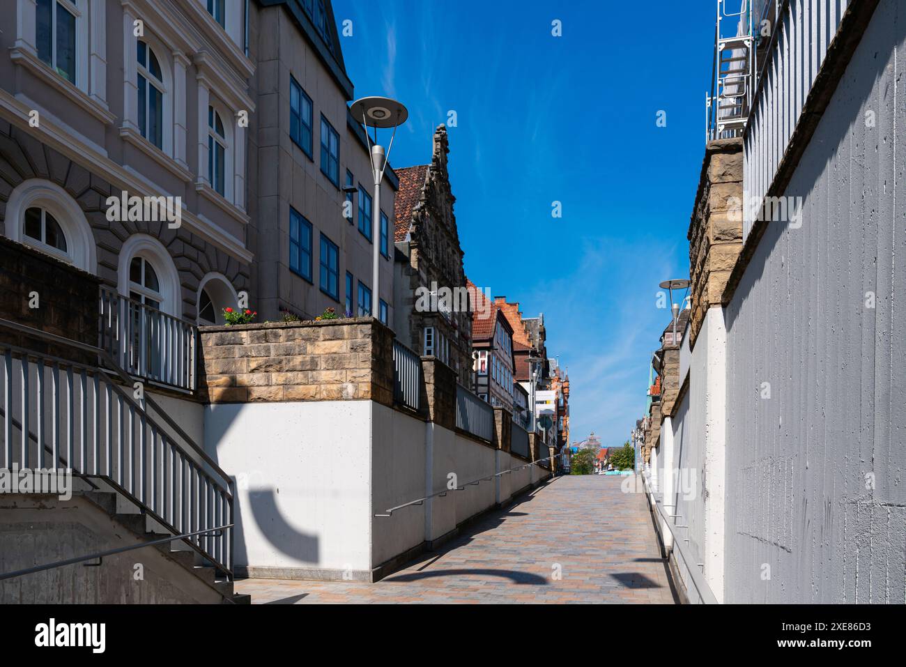 Narrow deserted street of an ancient German city against the blue sky ...
