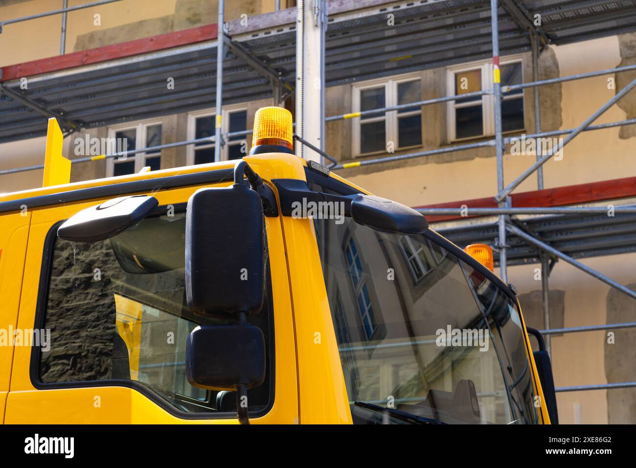 Top of yellow construction vehicle cab with flashing orange lights ...