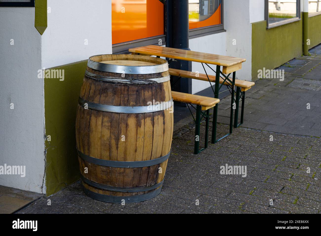 Wooden table with benches and a wooden barrel near a roadside cafe on ...