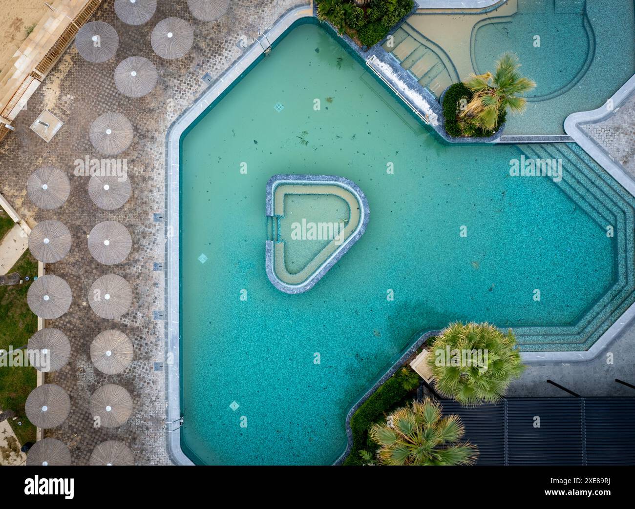 Drone aerial of empty abandoned deserted swimming pool. Dirty water ...