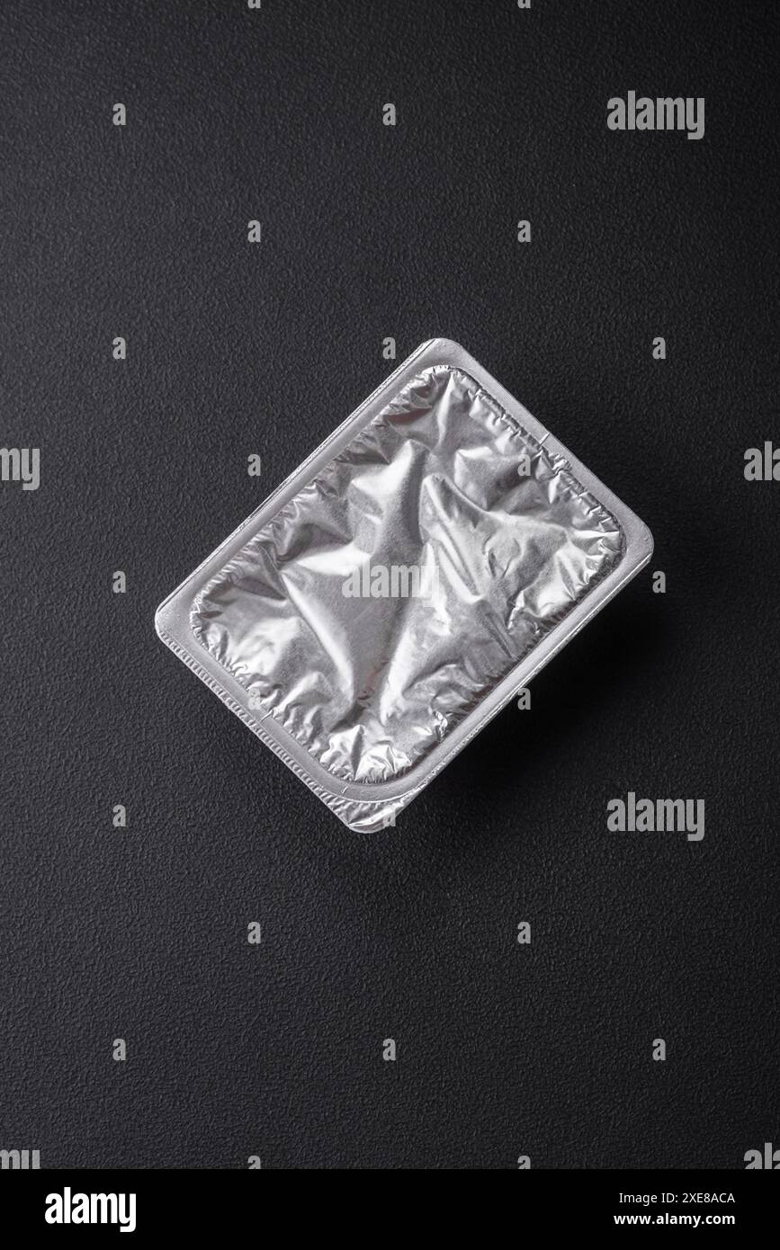 Rectangular plastic box with yogurt or cheese hermetically sealed with ...