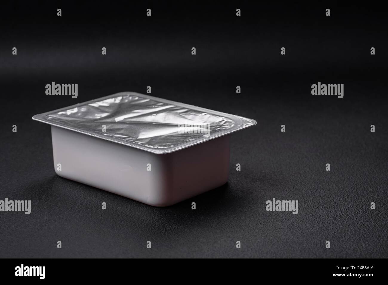 Rectangular plastic box with yogurt or cheese hermetically sealed with ...