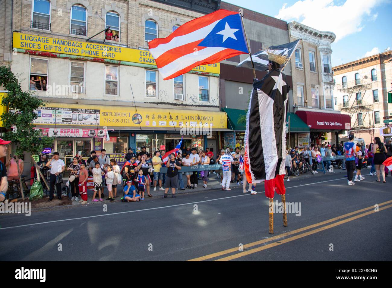 Stilt walker carries the now well know black and white Puerto Rican ...