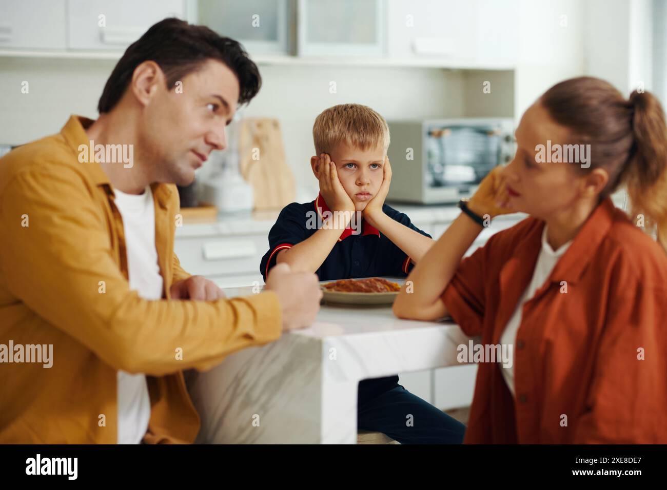 Little son worrying the quarrel of his parents while they arguing in ...