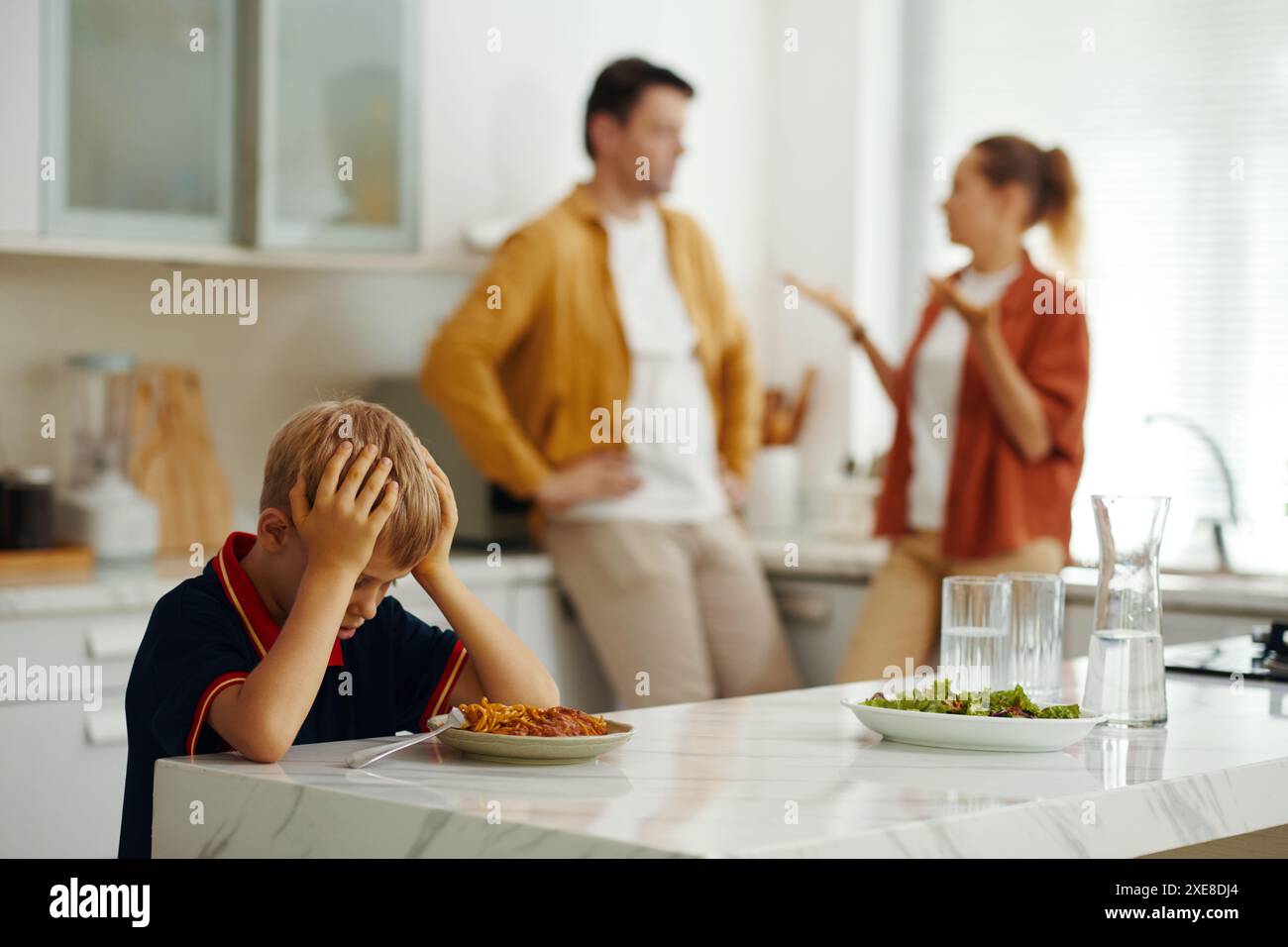 Upset child tired of conflict of his parents while they arguing in ...