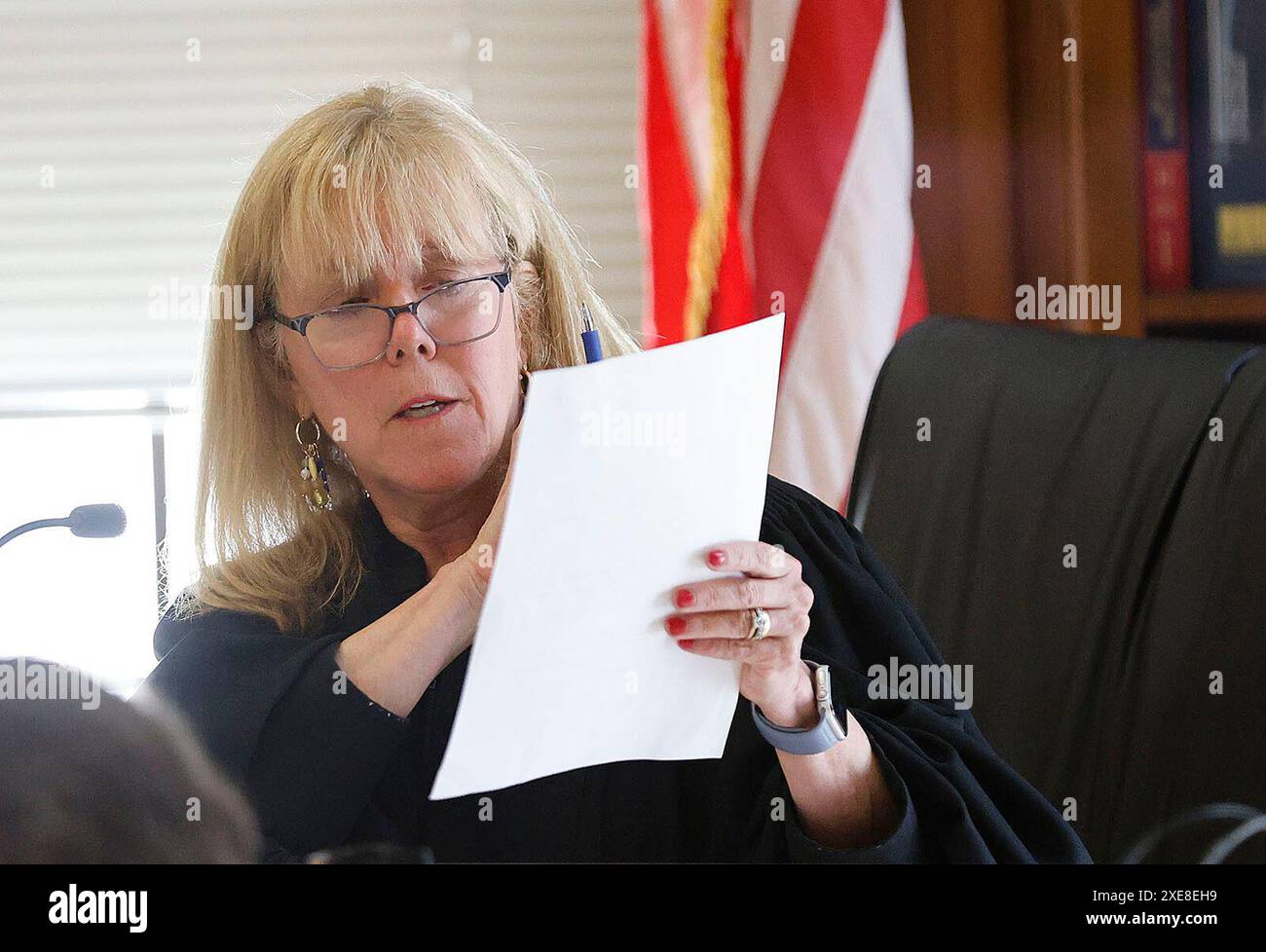 Judge Beverly Cannone looks over the verdict slip the jurors have to ...
