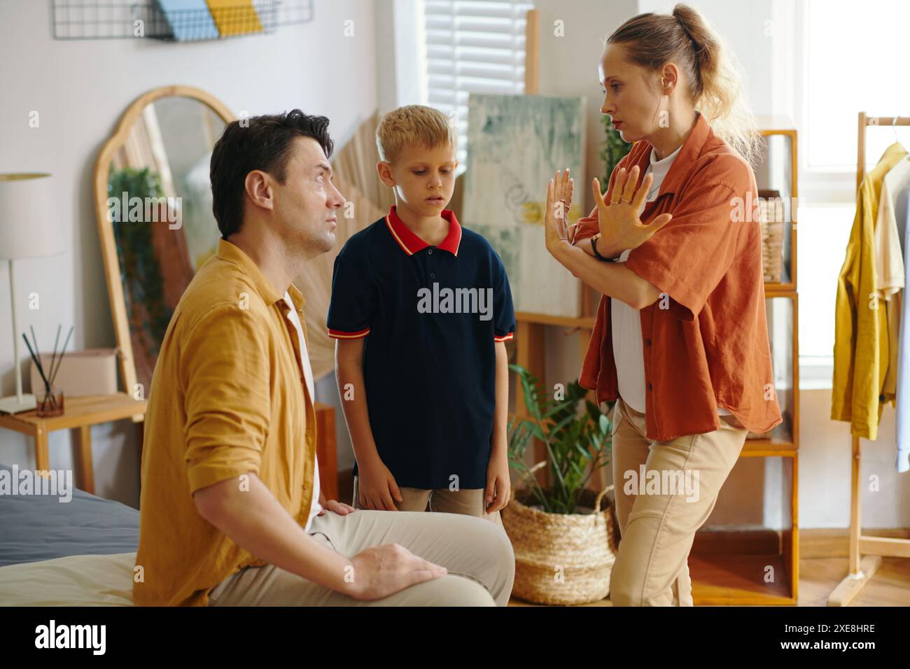 Parents having conflict in the presence of his son in the bedroom Stock ...
