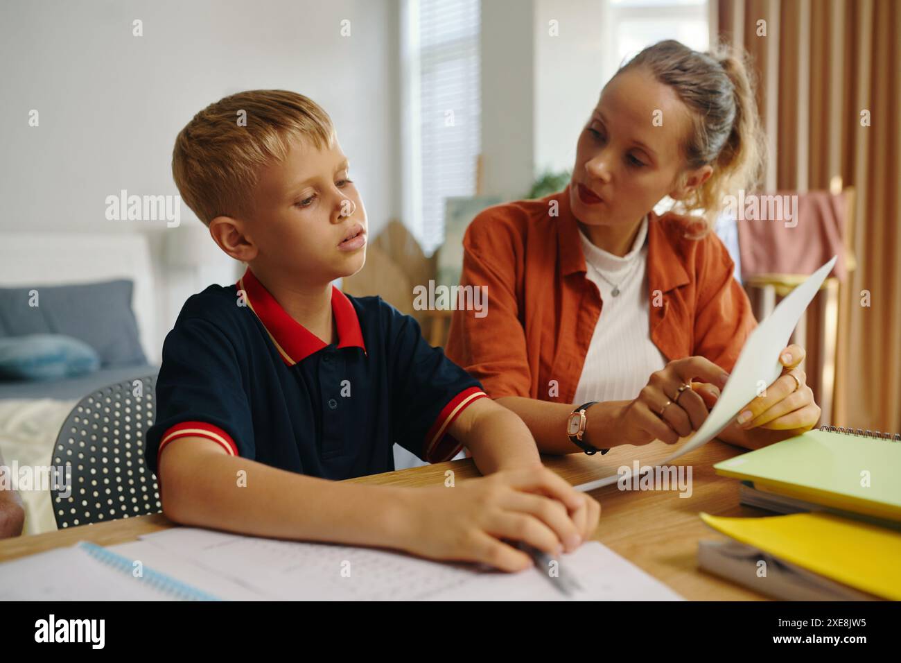 Mother Explaining Topic To Her Son Stock Photo - Alamy