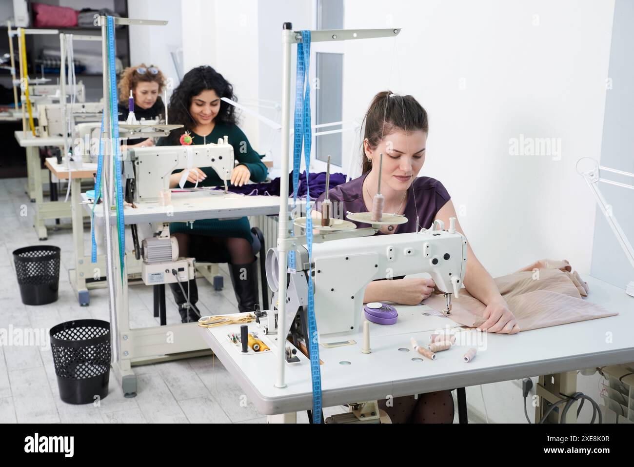 Female tailor sewing clothes hi-res stock photography and images - Alamy