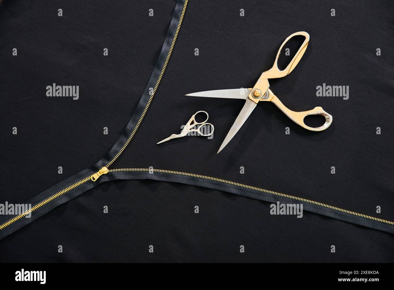 Tailor background with open golden zipper and two scissors in atelier ...