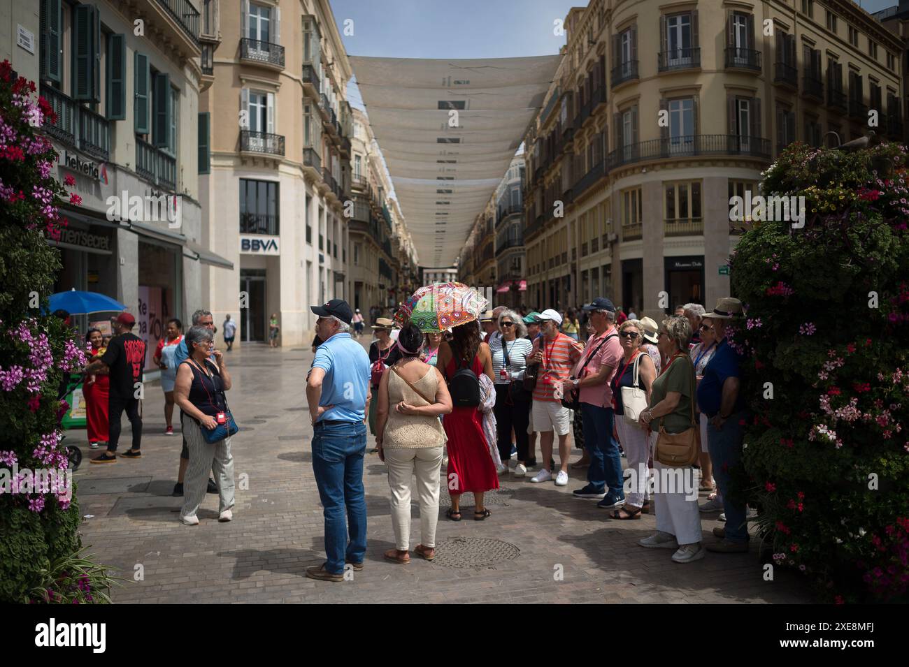 June 26, 2024, Malaga, Spain: Tourists are seen listening a tour guide ...