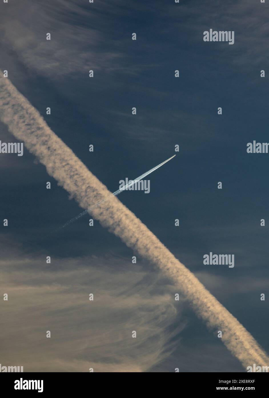 A commercial passenger jet aircraft leaves a contrail in its wake as it ...