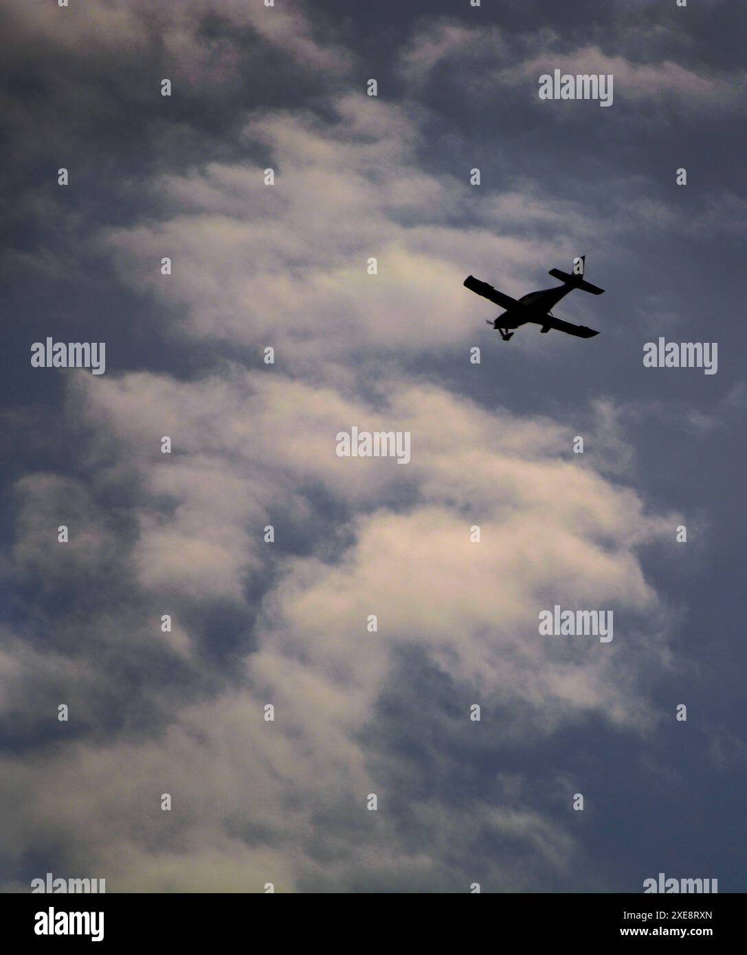 A small private single-engine airplane flies over Asheville, North ...