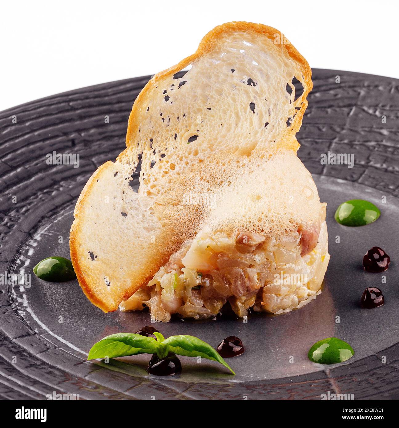 Sea bass tartare with toasted bread Stock Photo - Alamy
