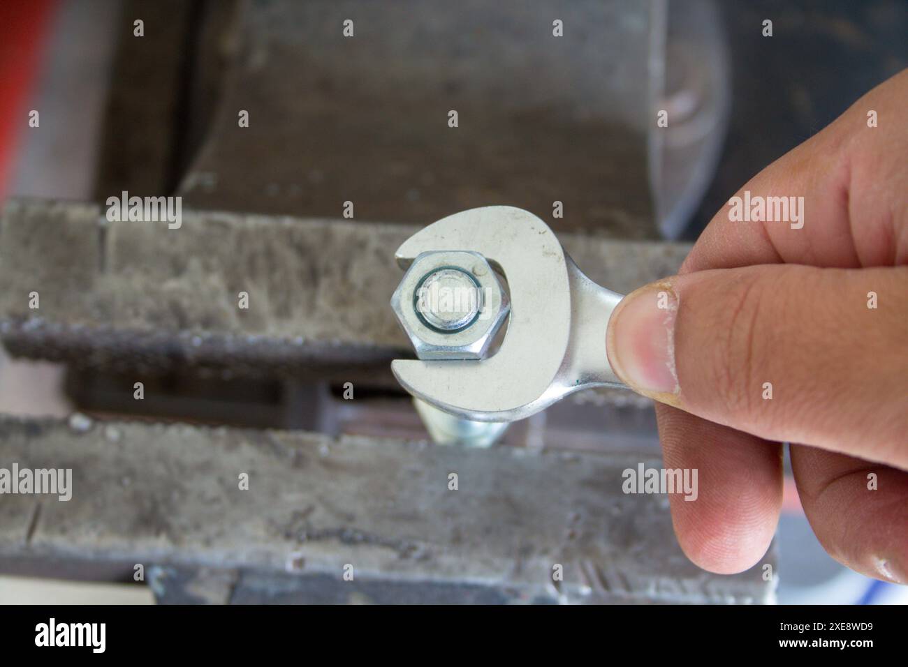 Image of a mechanic's hand tightening a bolt with a wrench. DIY work in ...