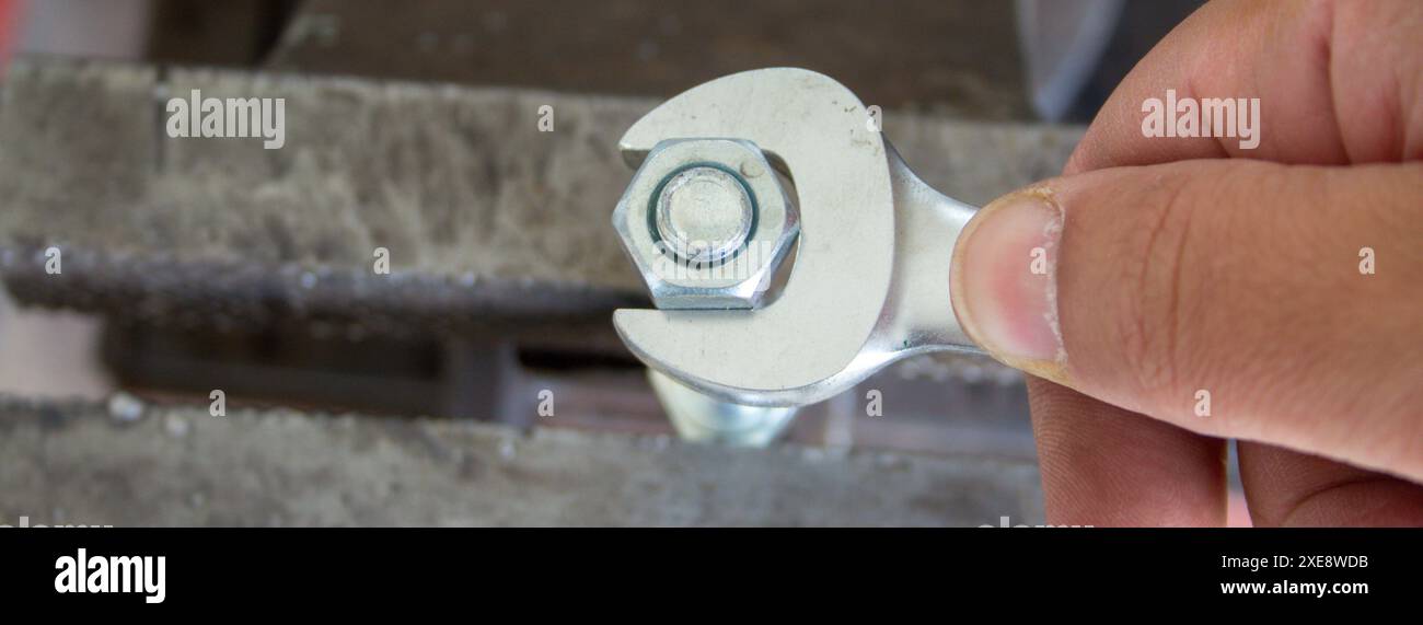 Image of a mechanic's hand tightening a bolt with a wrench. DIY work in ...