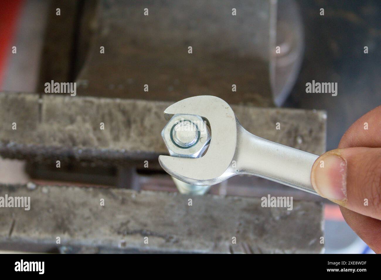 Image of a mechanic's hand tightening a bolt with a wrench. DIY work in ...